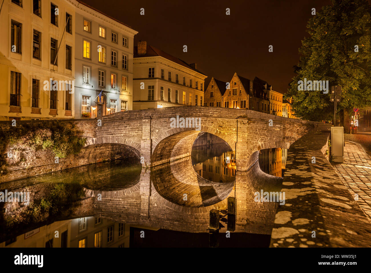 Romantic nocturnal view of a canal in Bruges. Night view of famous ...