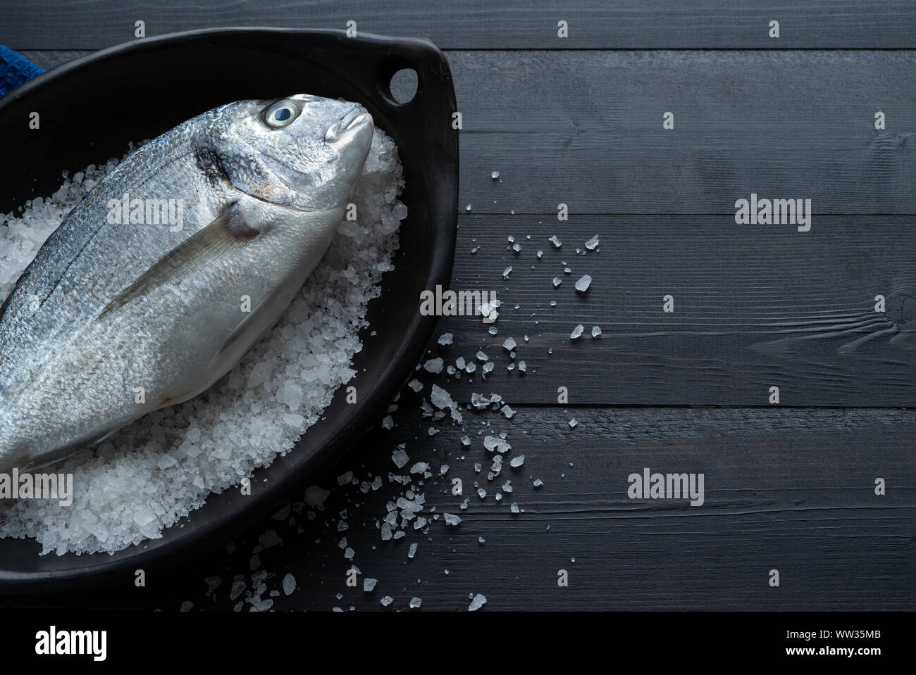 Process of preparation of sea bream salt. Sparus aurata Stock Photo - Alamy
