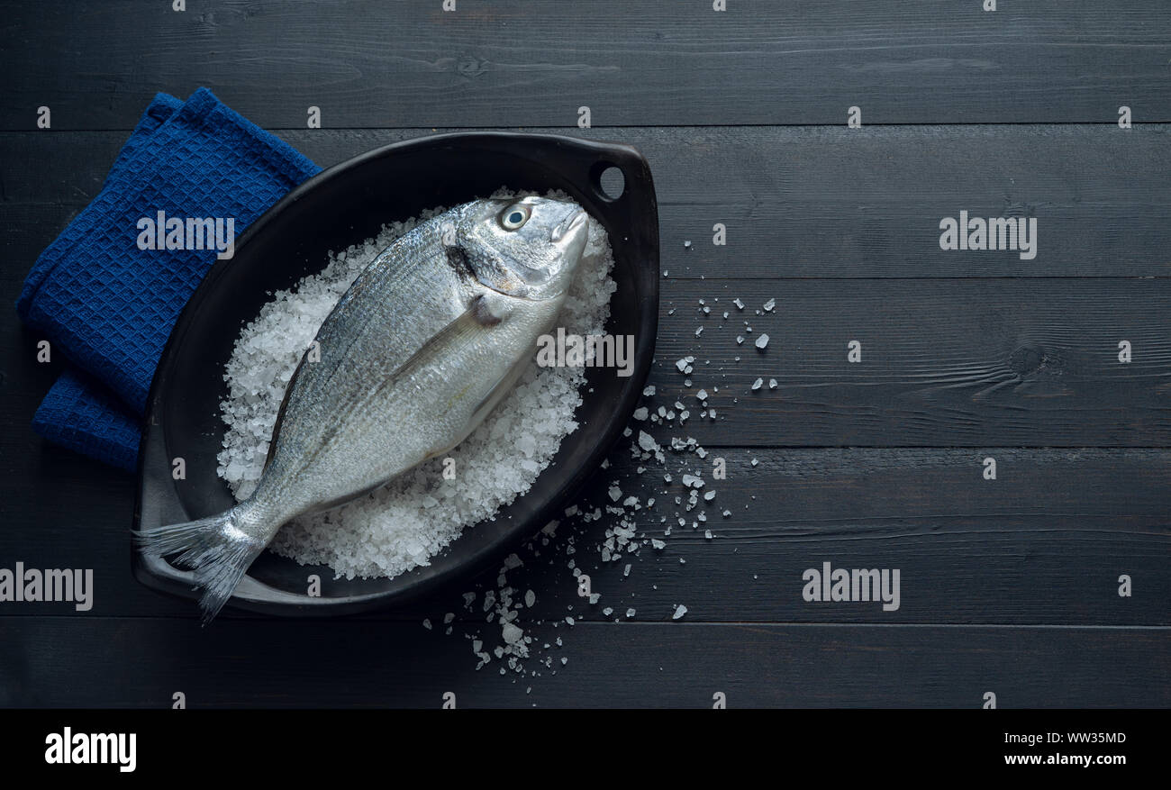 Process of preparation of sea bream salt. Sparus aurata Top view. Dark ...