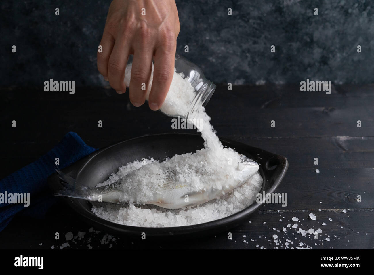 Process of preparation of sea bream salt. Sparus aurata Stock Photo - Alamy
