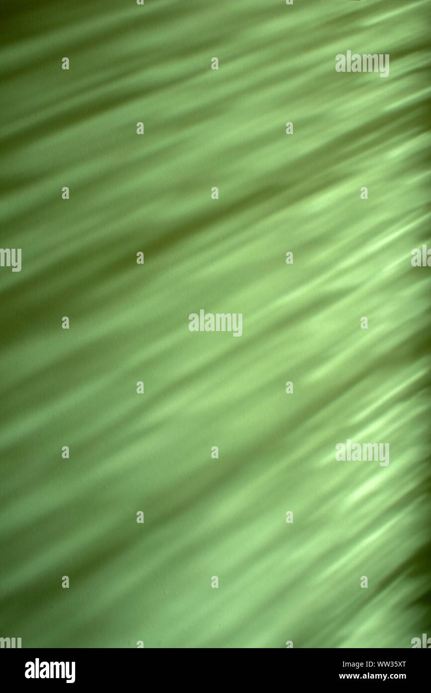 Light reflected on a wall and coloured green Stock Photo - Alamy