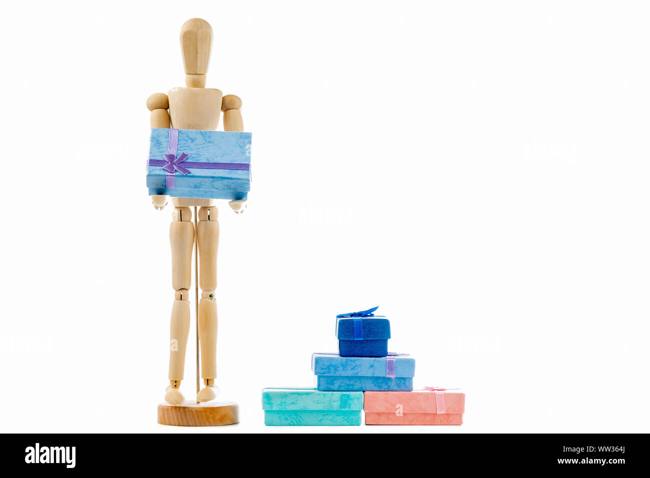 Wooden mannequin with gifts on white background Stock Photo - Alamy