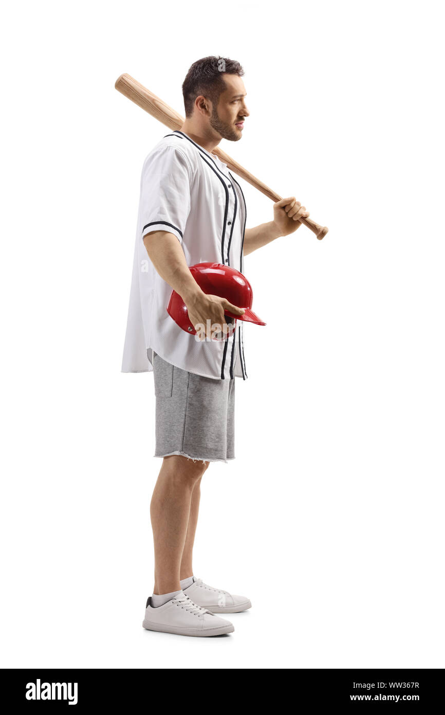 Full length profile shot of a man holding a baseball bat and a red ...