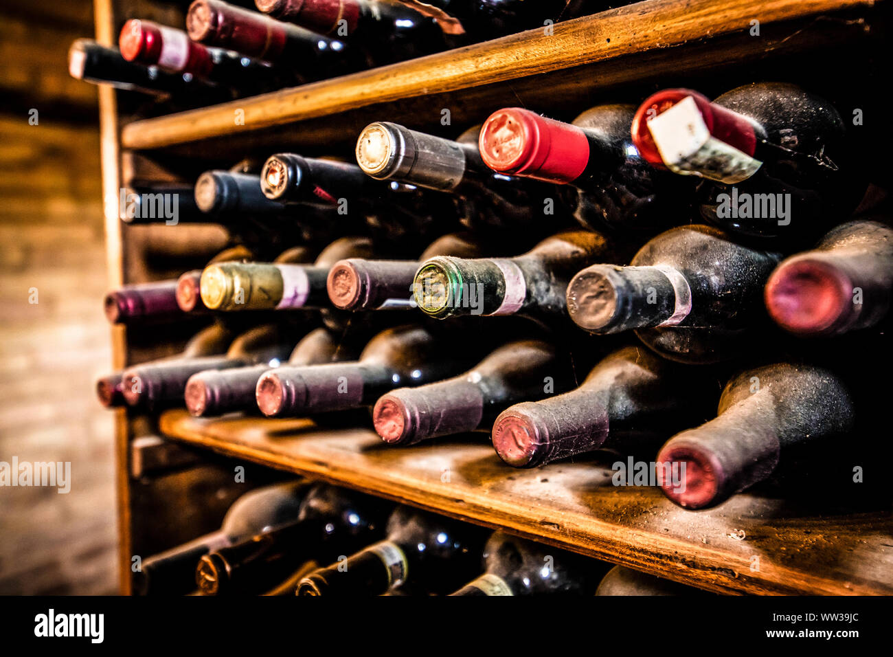 Old and dusty bottle of wine in a typical cellar Stock Photo - Alamy