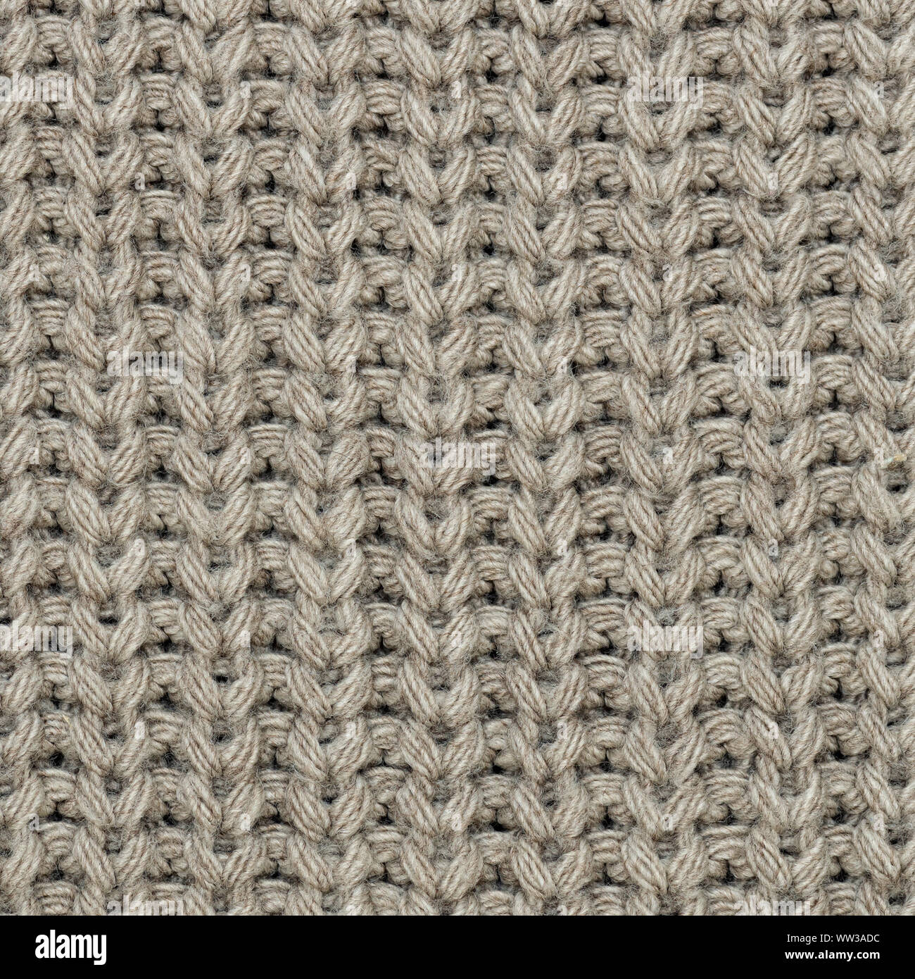 The texture of the knit fabric is beige. Close-up. Abstract background ...