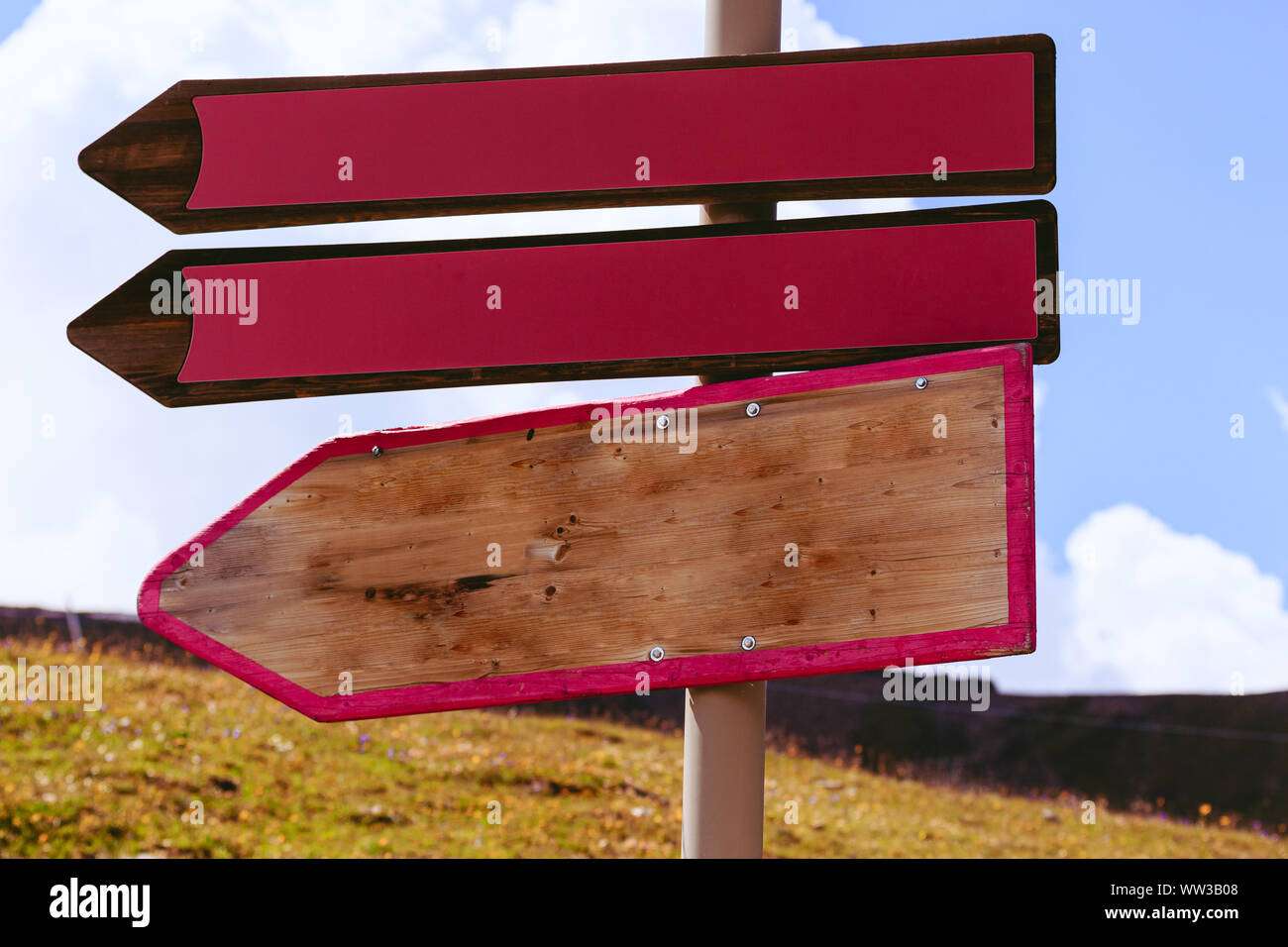 Three empty wooden direction signs pointing left Stock Photo - Alamy