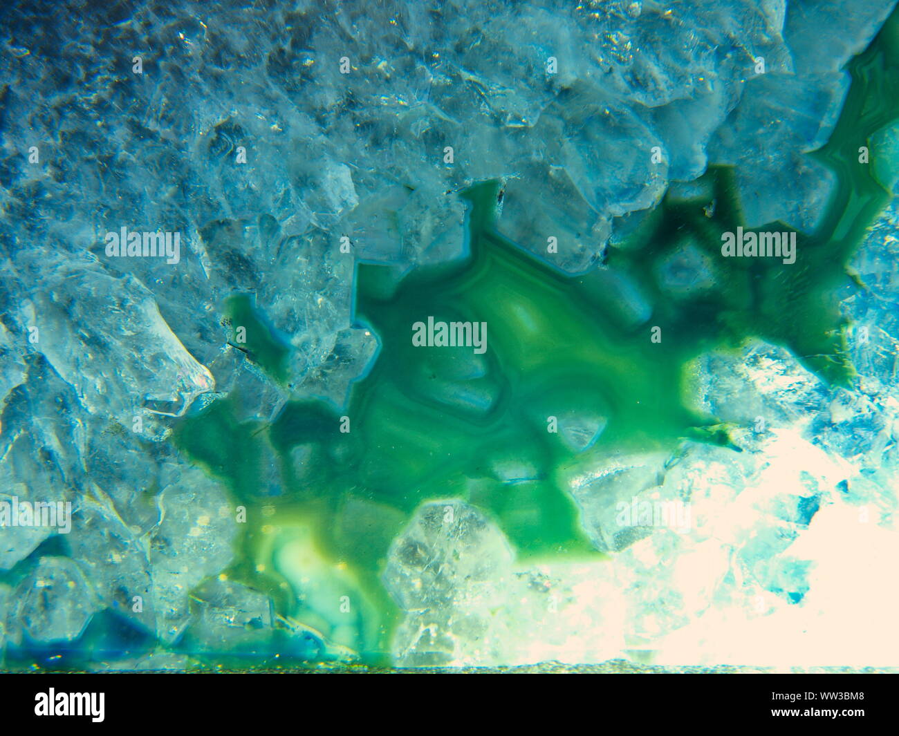 A closeup-macro photograph of a green agate Geode crystal geological ...