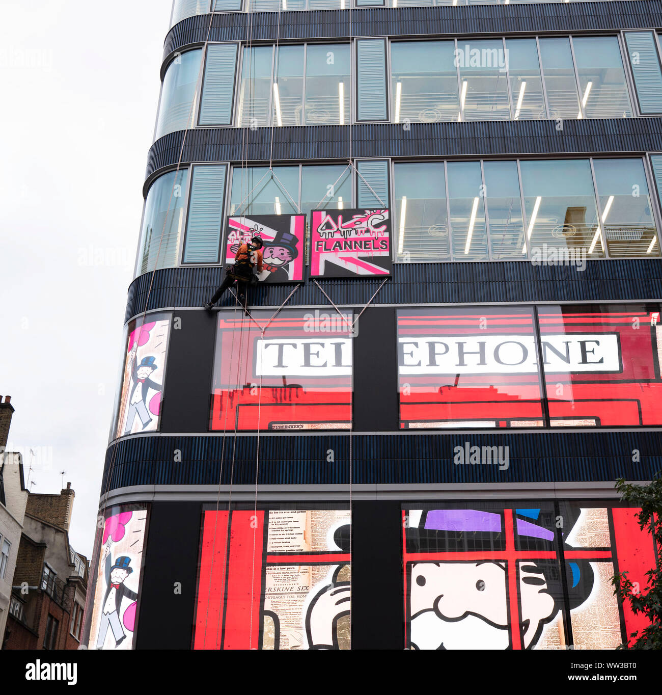 Street artist Alec Monoploy abseils down the Flannels store on Oxford ...