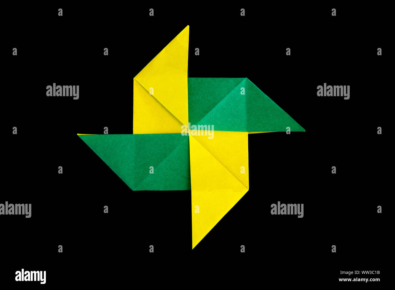Origami paper windmill isolated against a black background Stock Photo ...