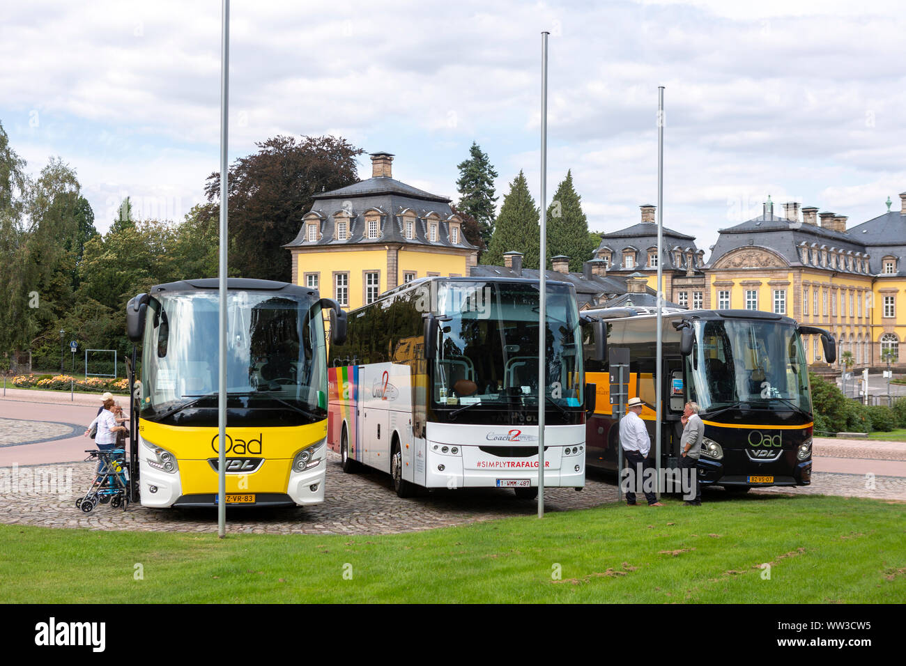 Senior citizen tourist next to a Dutch tourist bus of the Oad travel ...