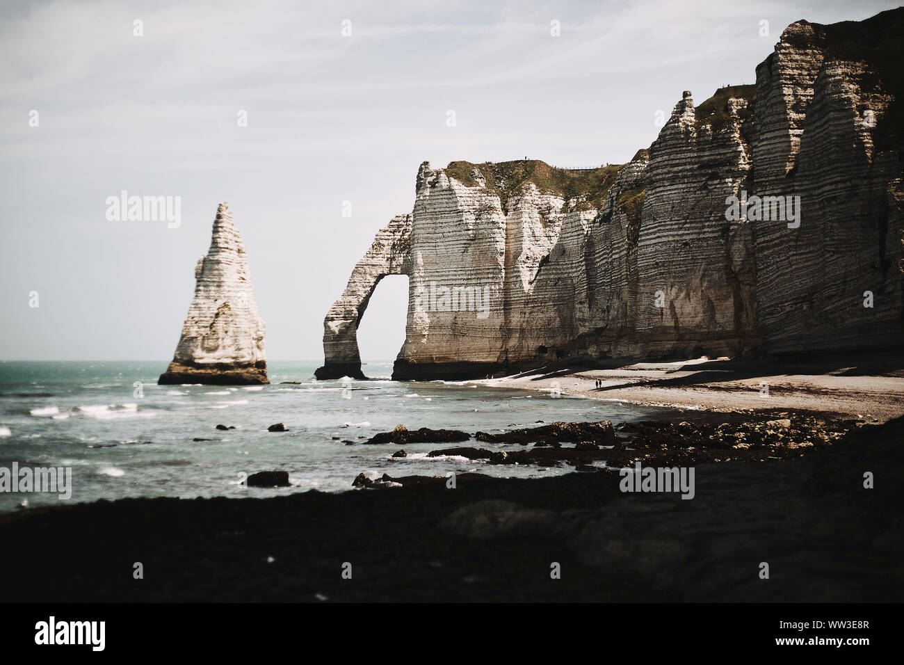 Huge rocks in the light of evening sun in the Normandy seashore Stock ...