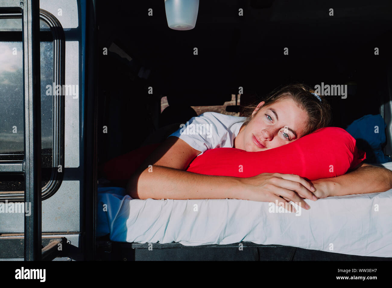 girl waking up while camping in campervan Stock Photo - Alamy