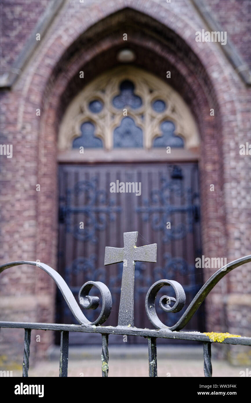 wooden gothic church door behind an iron gate with cross Stock Photo ...