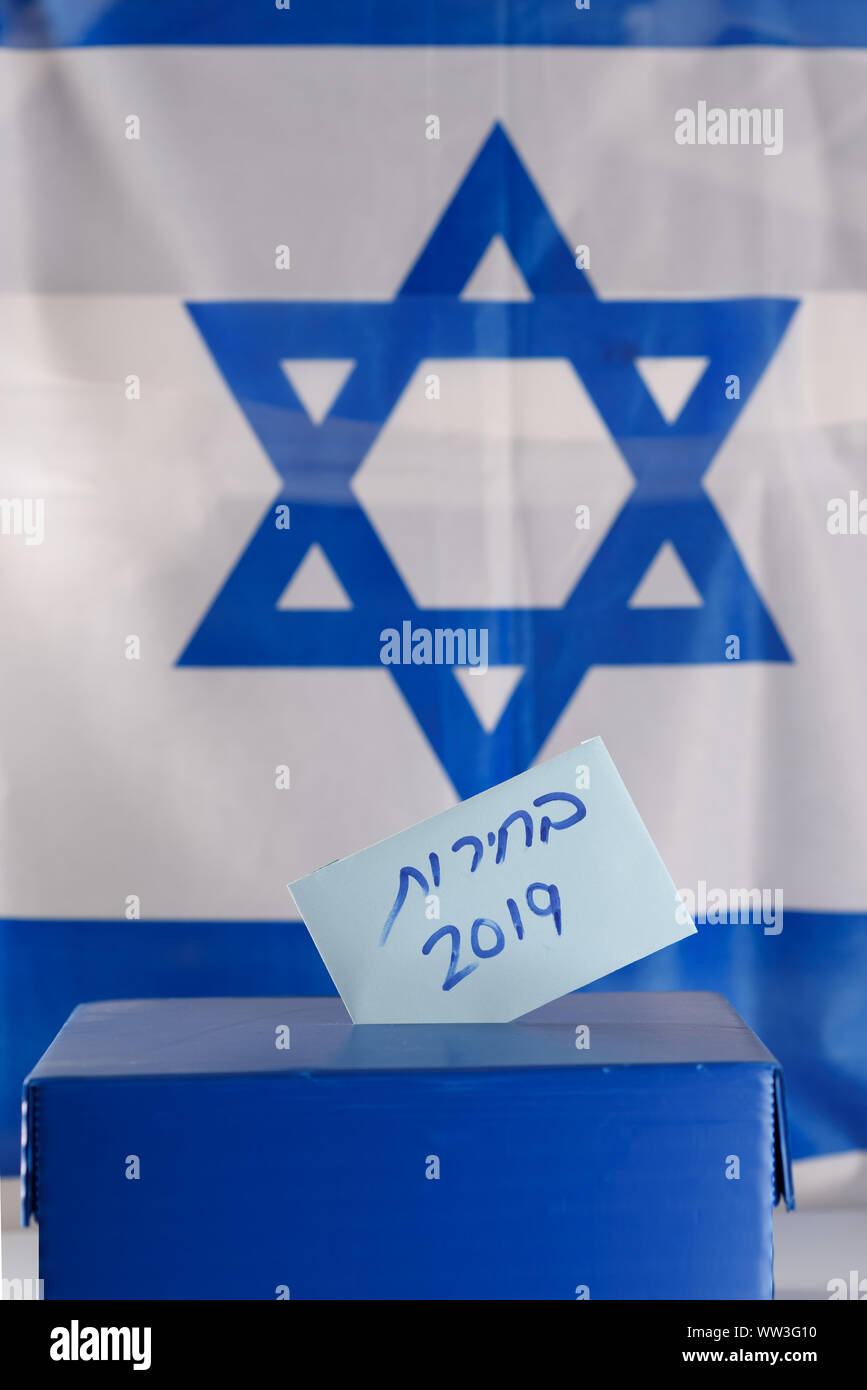 Vote box. Hebrew text Elections 2019 on voting paper over Israel flag ...