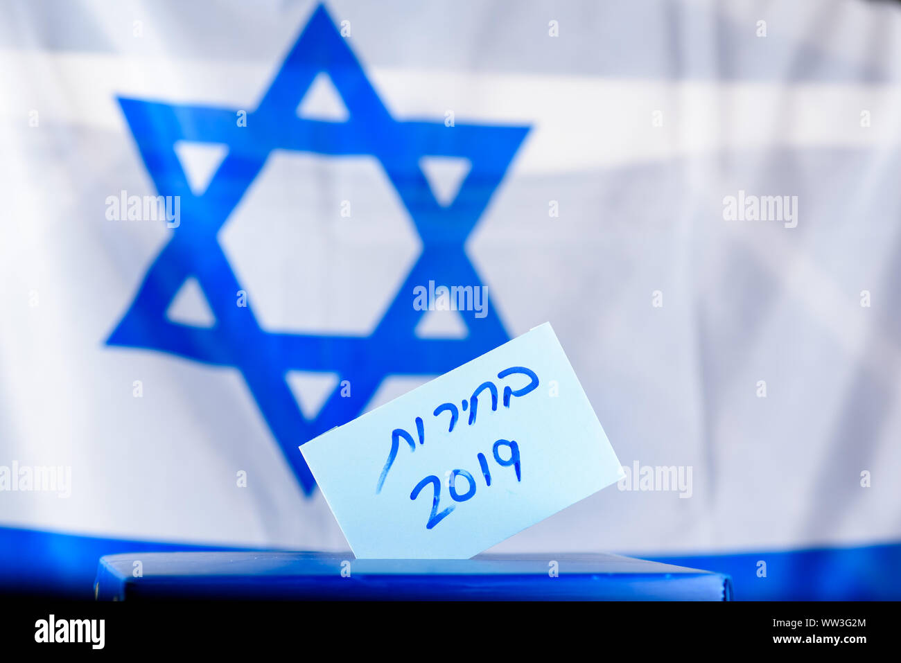 Vote box. Hebrew text Elections 2019 on voting paper over Israel flag ...
