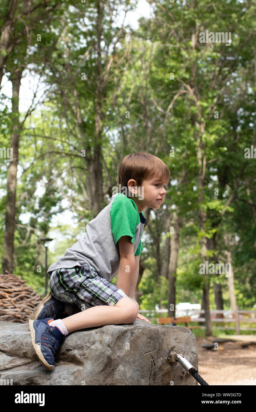 boy climbing rock Stock Photo - Alamy