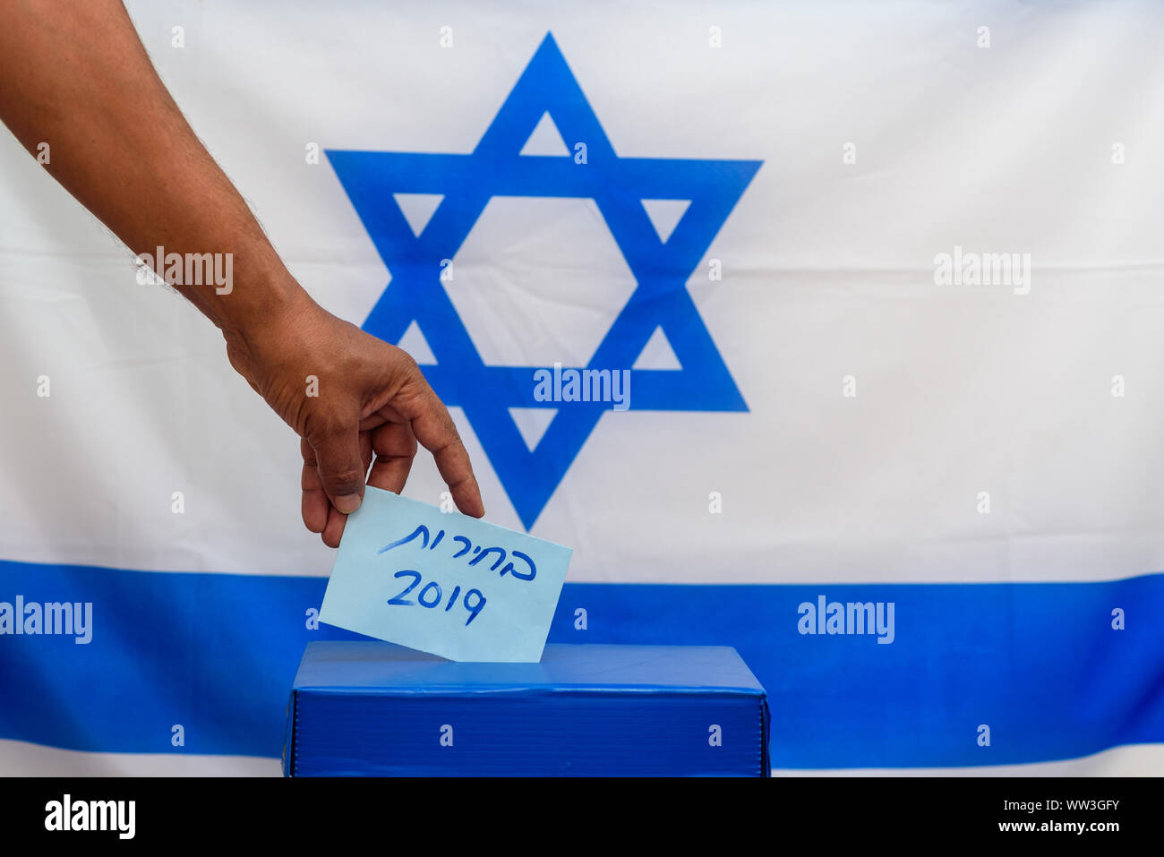Election in Israel - voting at the ballot box. The hand of man putting ...