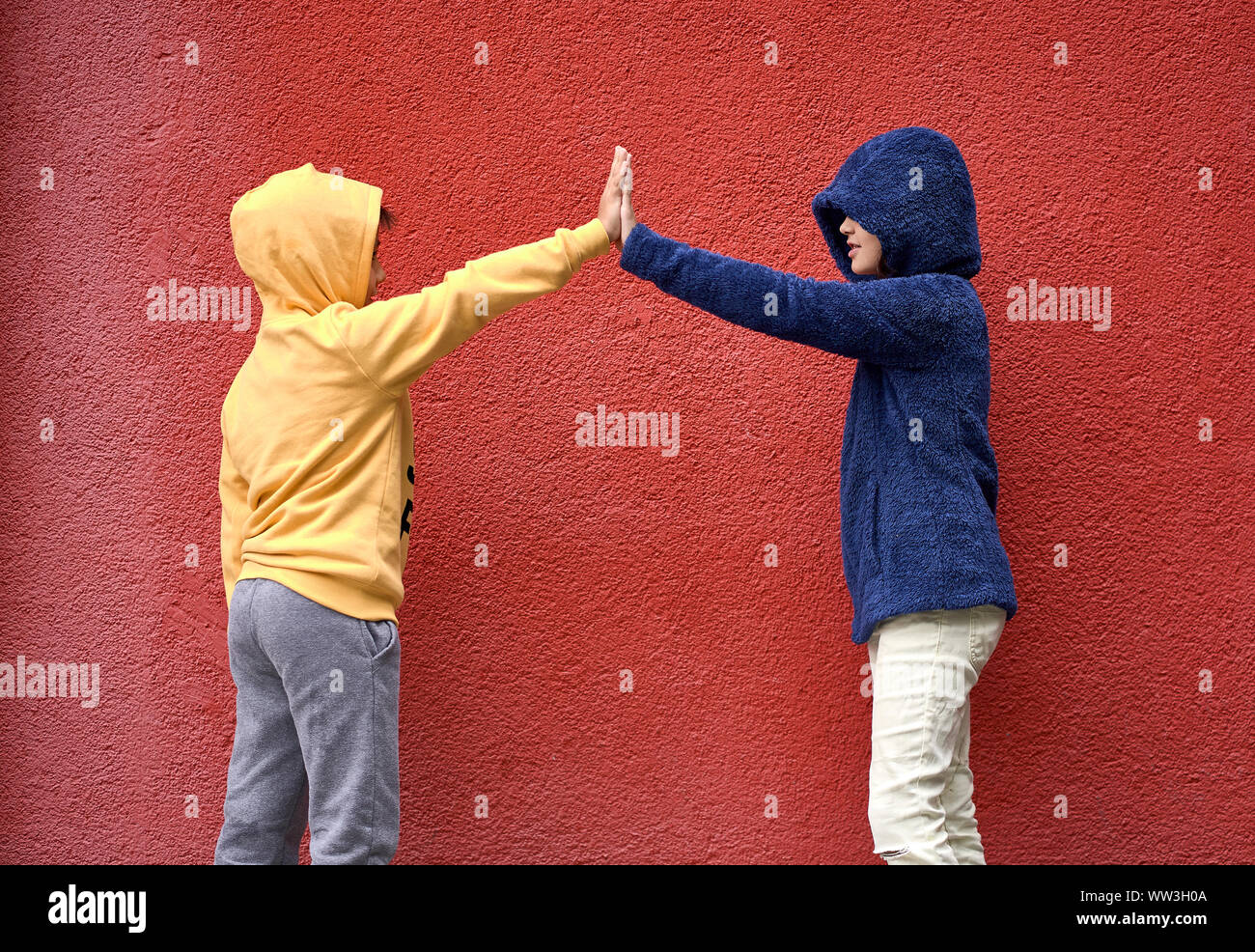 Boy and girl giving their hands Stock Photo - Alamy