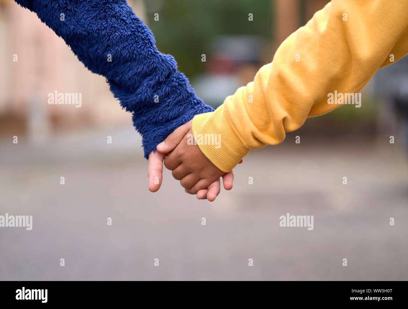 Boy and girl giving their hands Stock Photo - Alamy