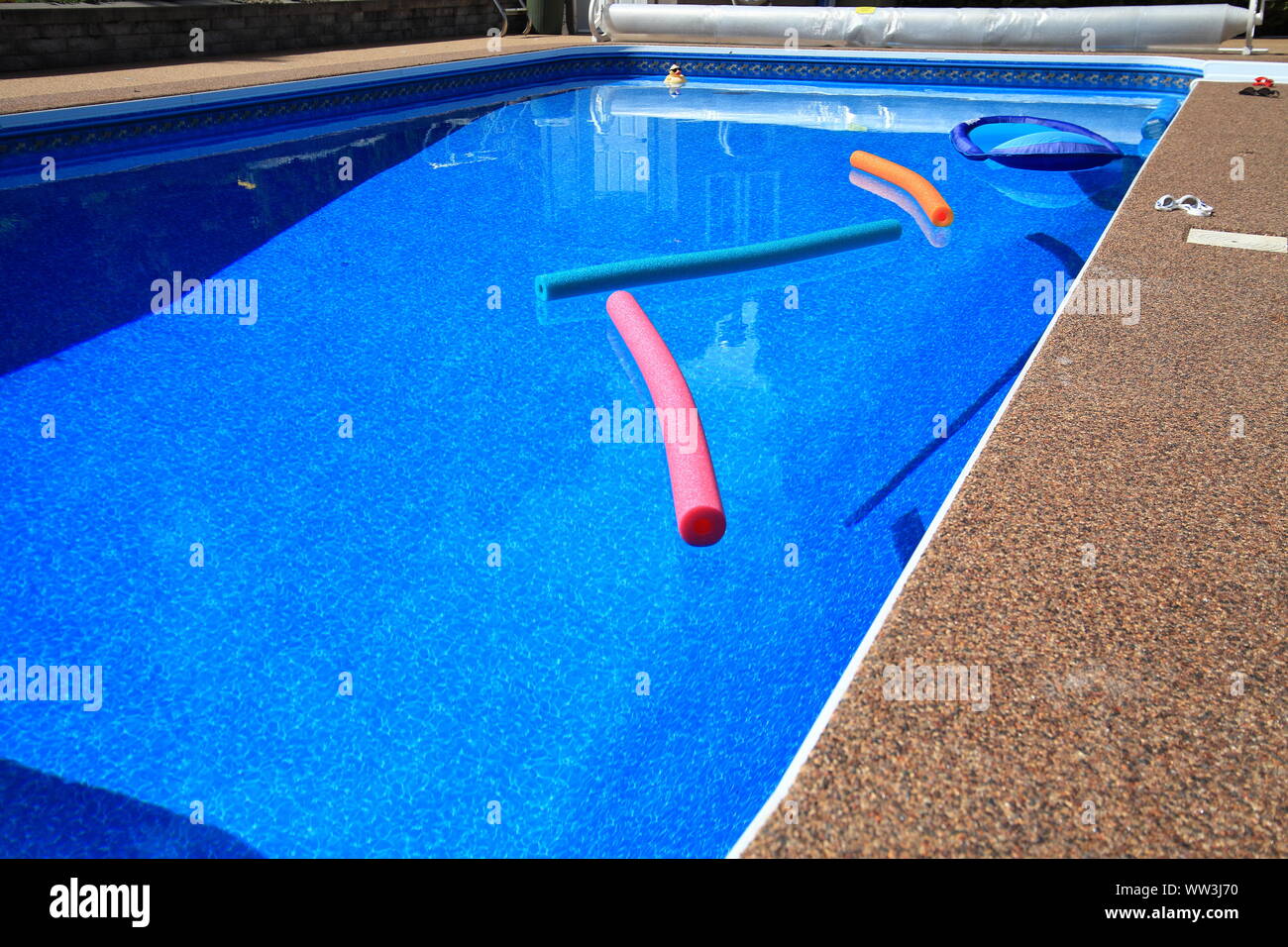 Empty private pool with toys from the last visitors Stock Photo - Alamy