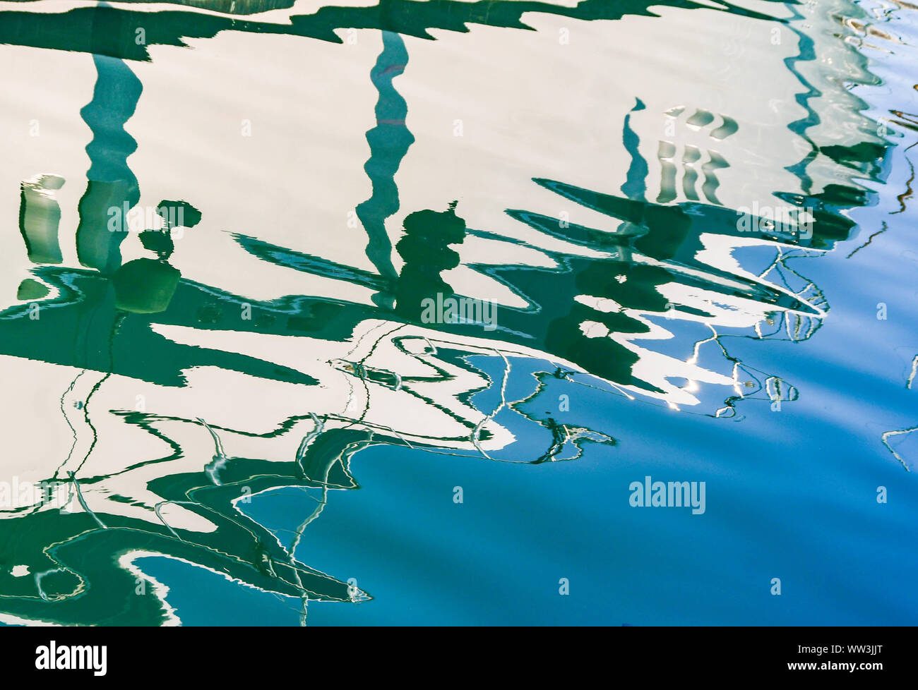 Pattern formed by the reflection of a boat in ripples on still water ...