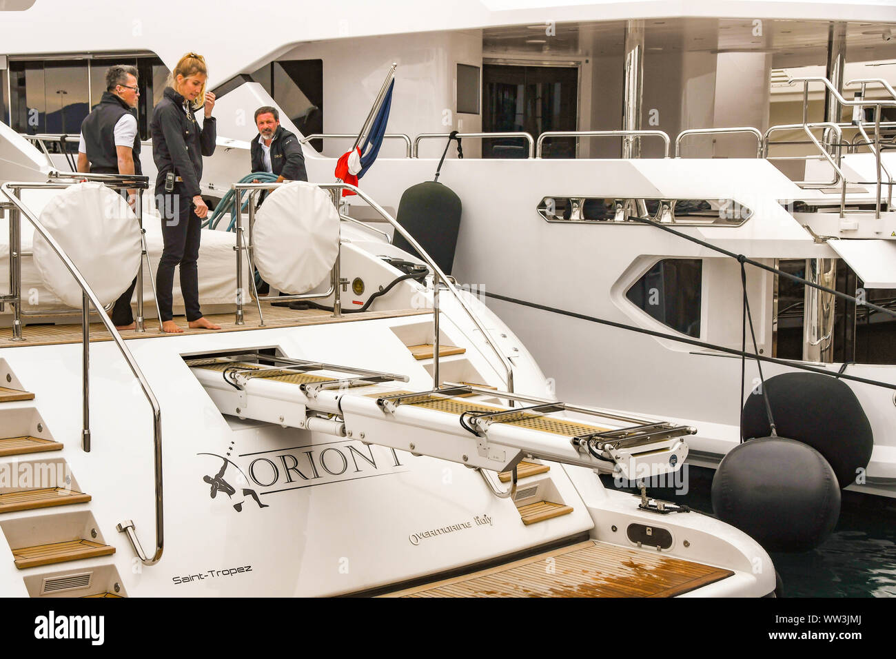 CANNES, FRANCE - APRIL 2019: Crew member on the back of a superyacht ...