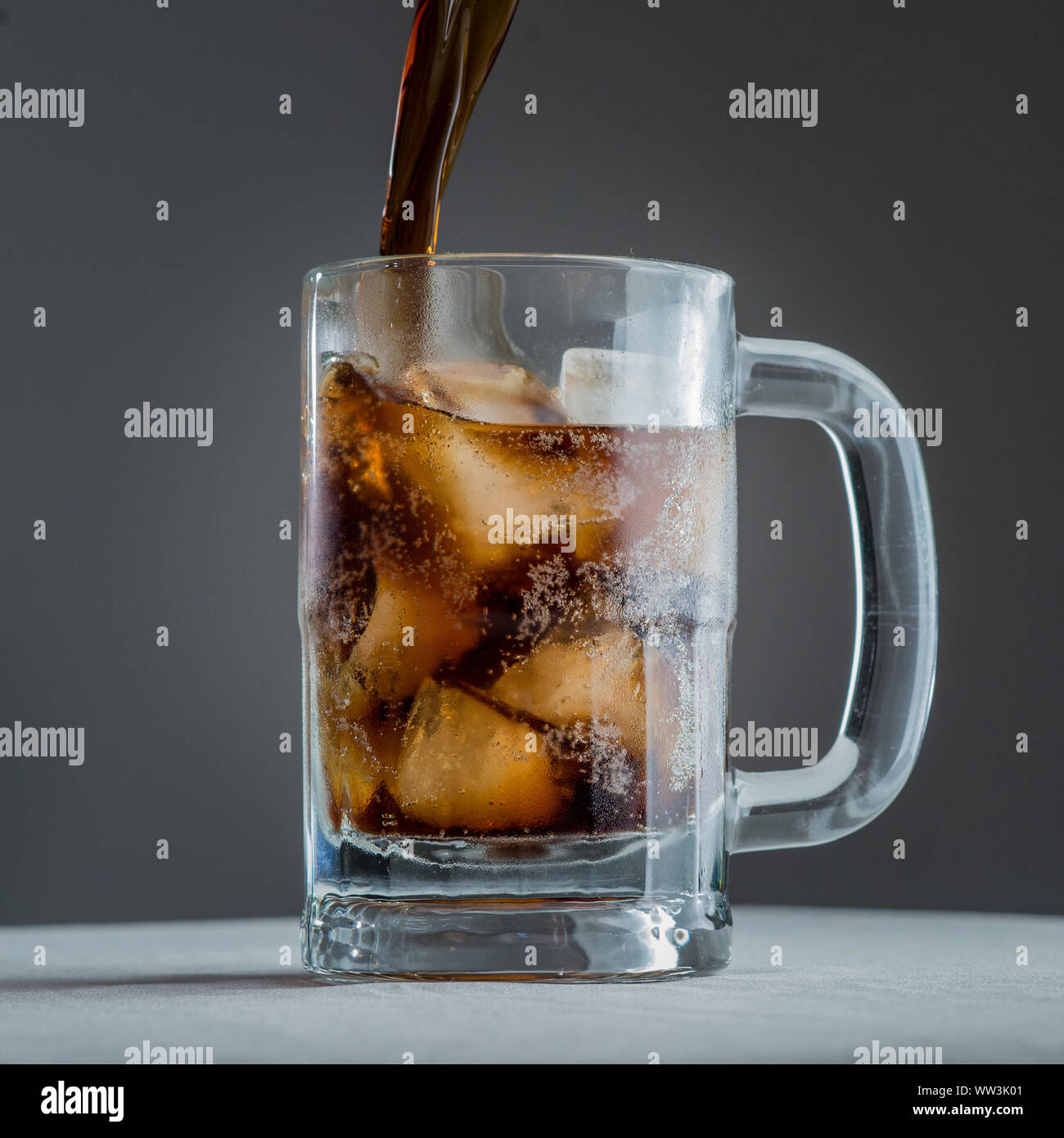 Refreshing glass mug of cola soda with ice Stock Photo - Alamy