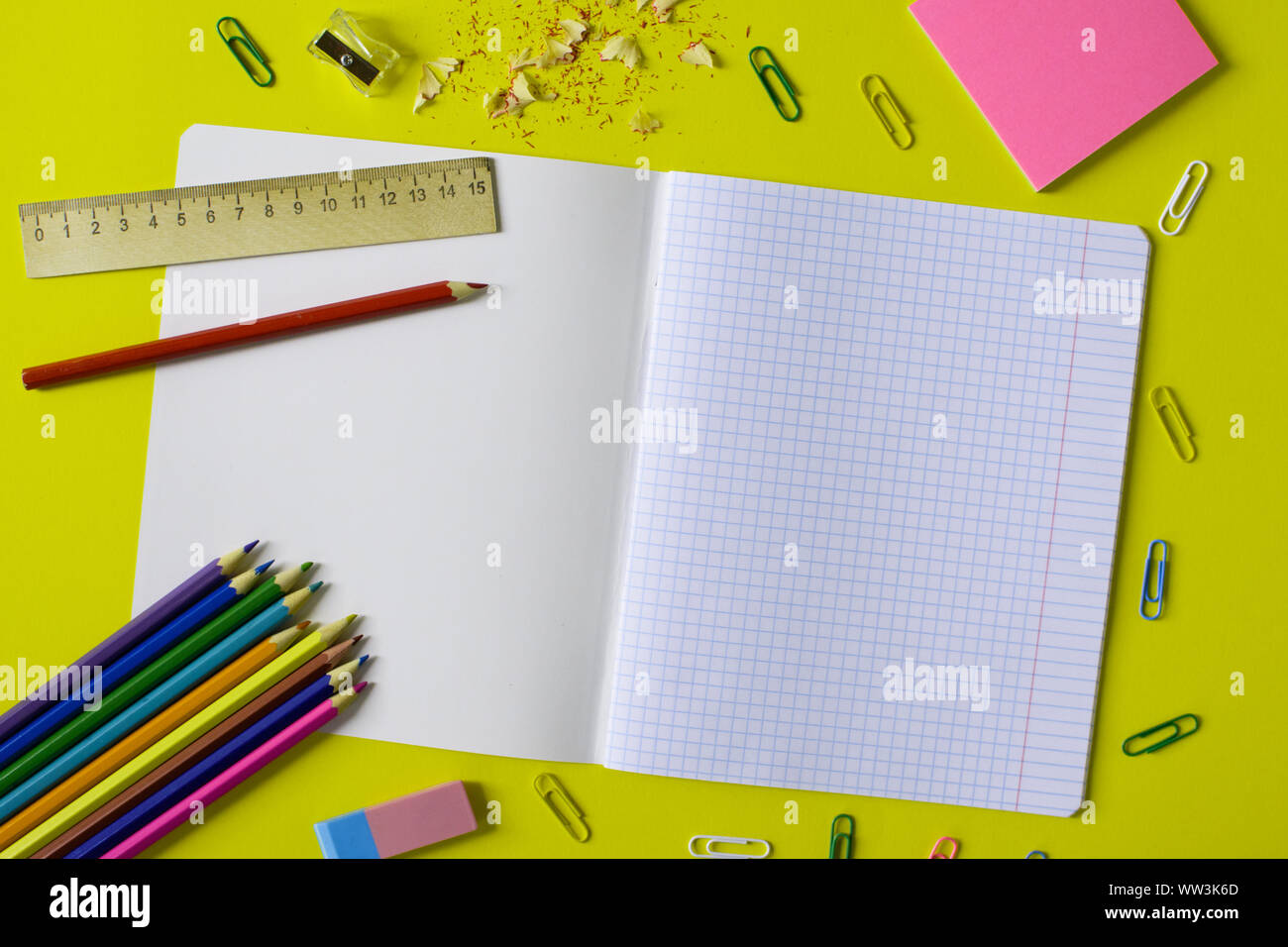 Notebook in a cage with a pencil, eraser, ruler, paper clips and other ...
