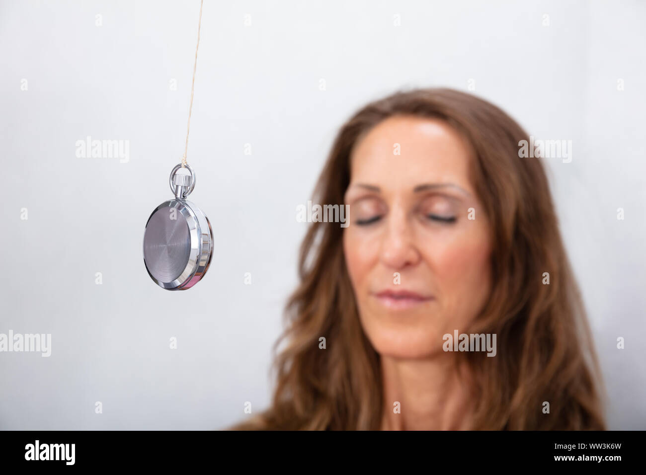 Attractive Mature Woman Being Hypnotized With Pendulum At Home Stock ...