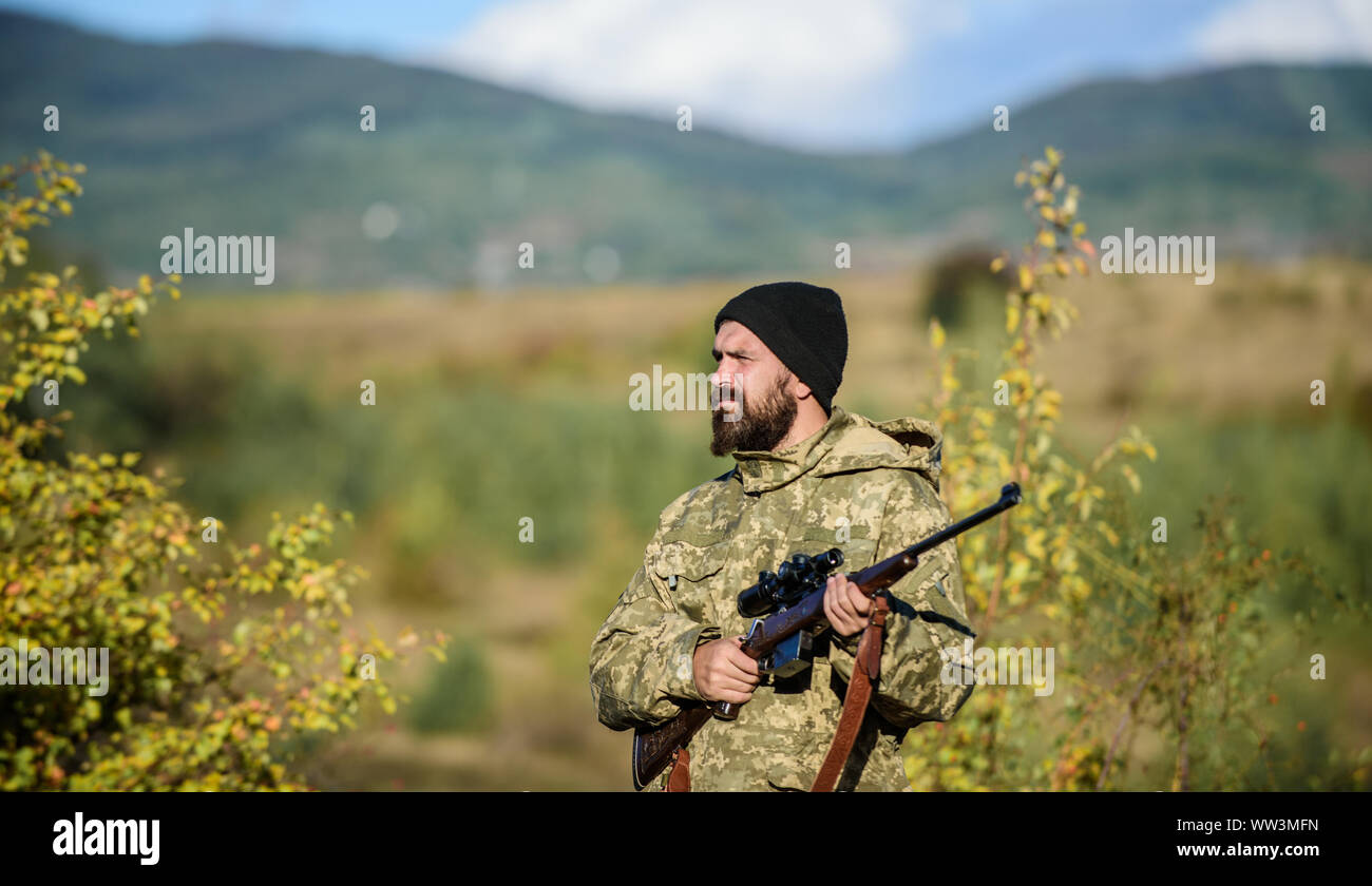 Hunter hold rifle. Bearded hunter spend leisure hunting. Focus and ...