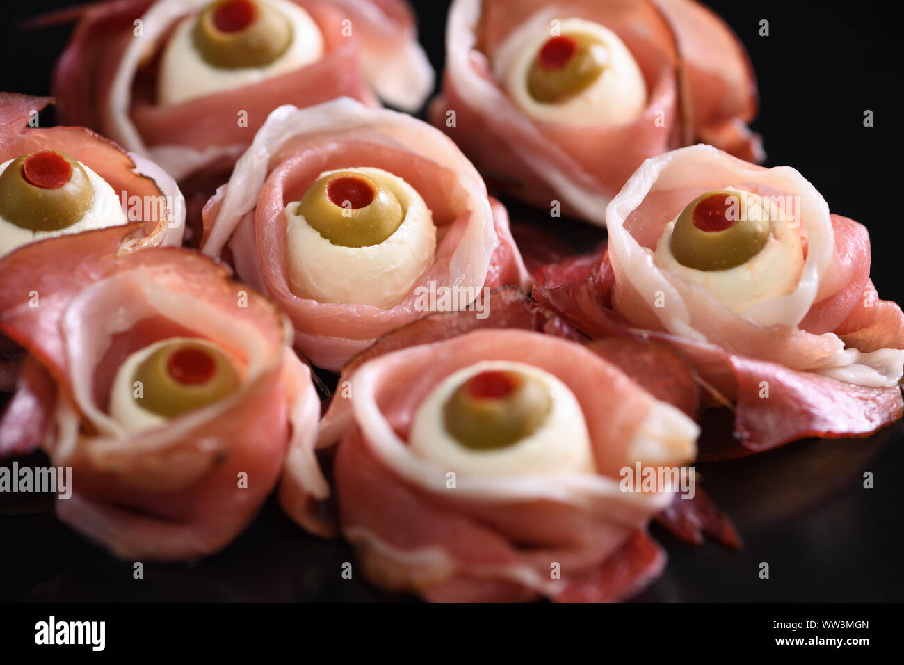 Original Halloween snacks. Eyeballs cooked from jamon with mozzarella ...
