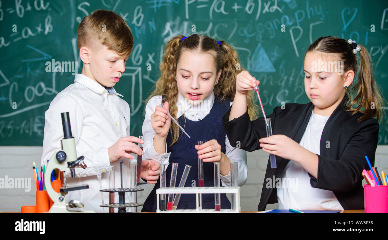 Group school pupils study chemical liquids. Girls and boy student ...