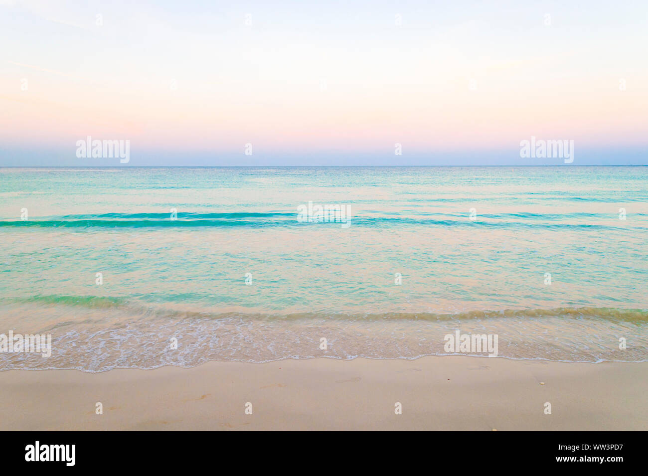 Tropical sea background of pastel sunset skies glowing above tranquil ...