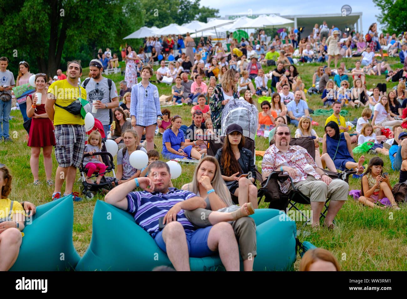 Girls friends watching concert at open air music festival, back view ...