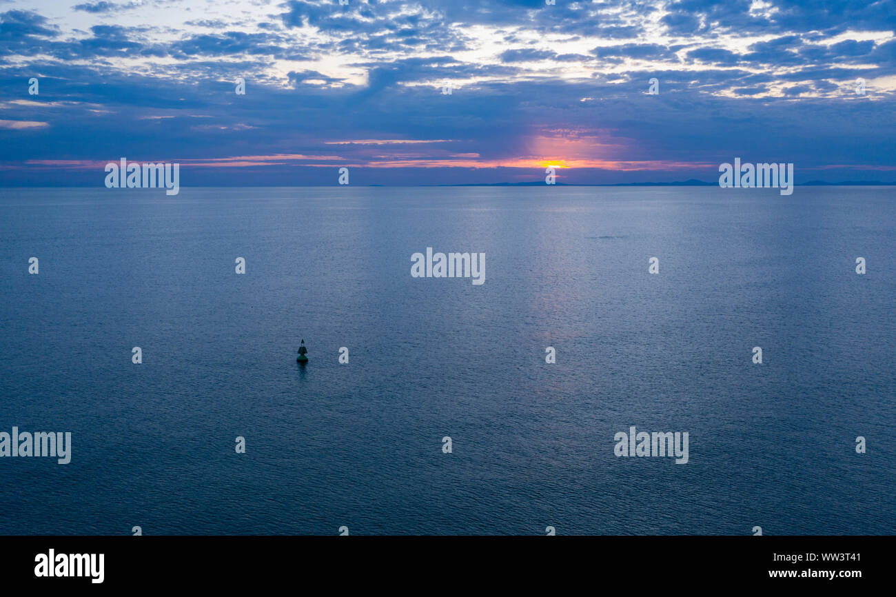 Dramatic sunset clouds over calm sea in Nirth Wales, UK Stock Photo - Alamy