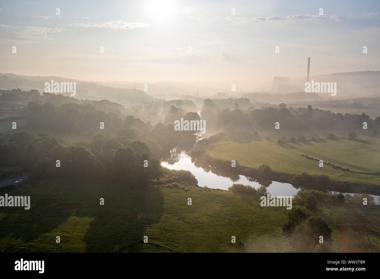 High altitude drone shoot over misty valley at sunrise. Severn River in ...
