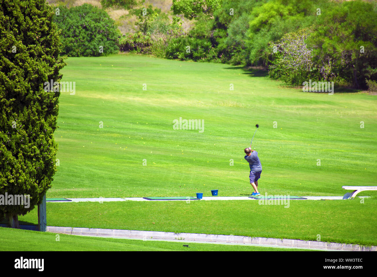 Sportsman performing a golf swing at the golf court in Alicante, Spain ...