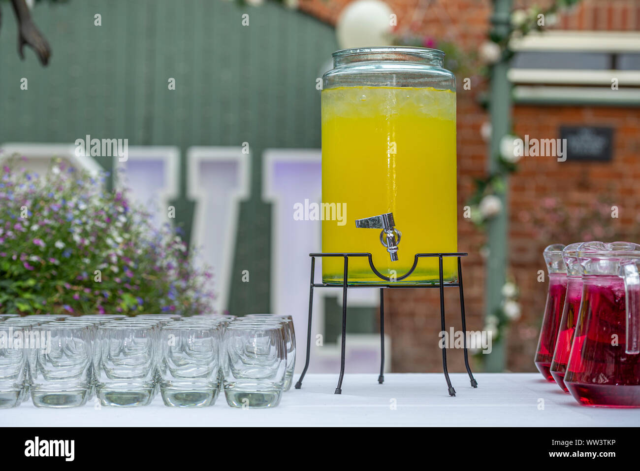 Chilled party lemonade in vintage style glass dispenser on the top of ...
