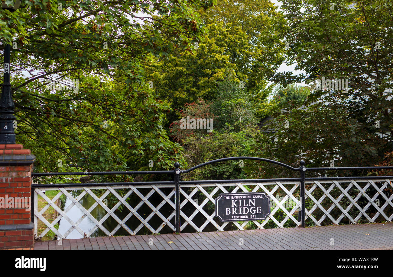 Kiln Bridge, a road bridge over the Basingstoke Canal with a name plate ...