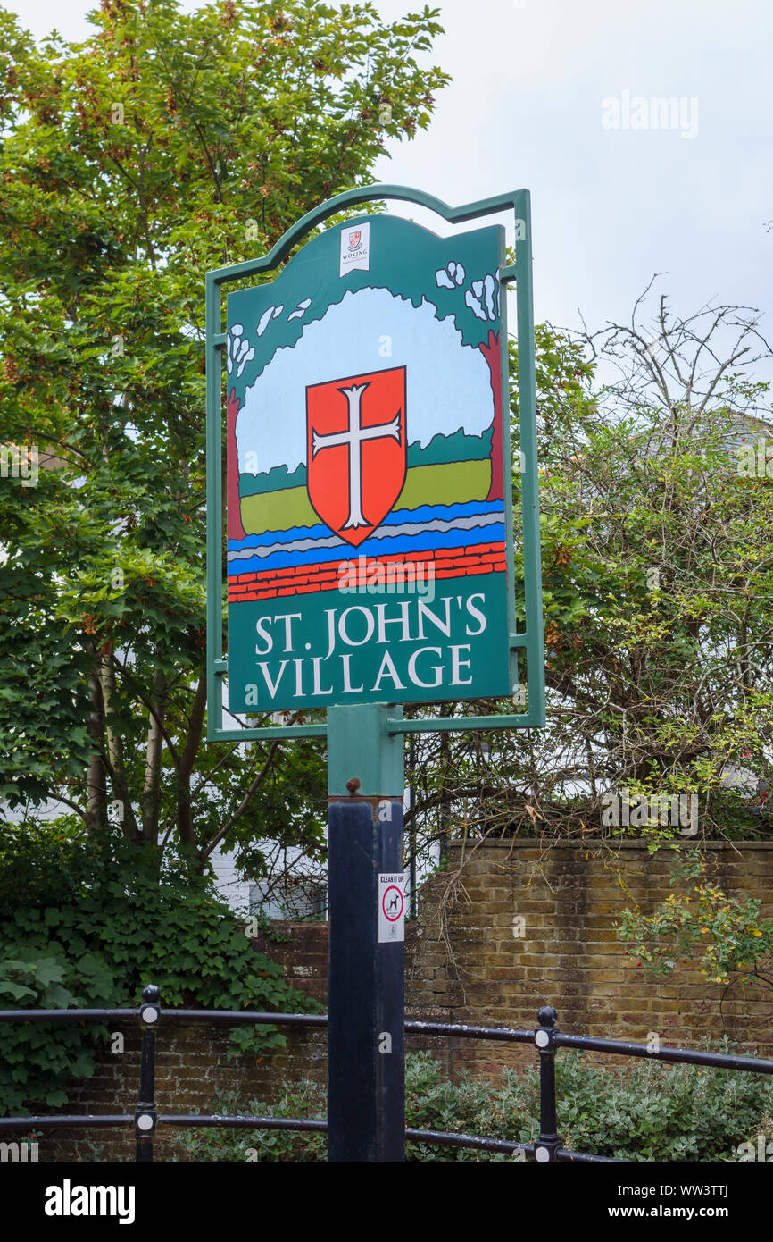 Colourful large green name sign with a heraldic crest and red shield in ...