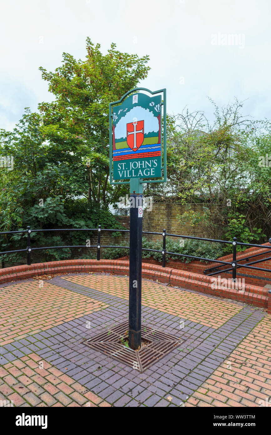 Colourful large green name sign with a heraldic crest and red shield in ...