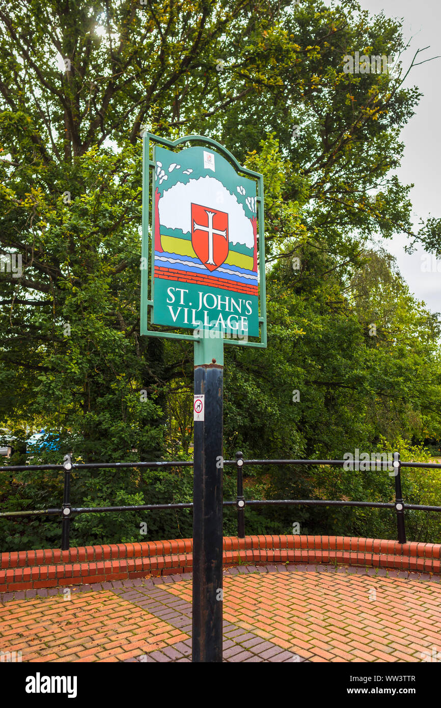 Colourful large green name sign with a heraldic crest and red shield in ...