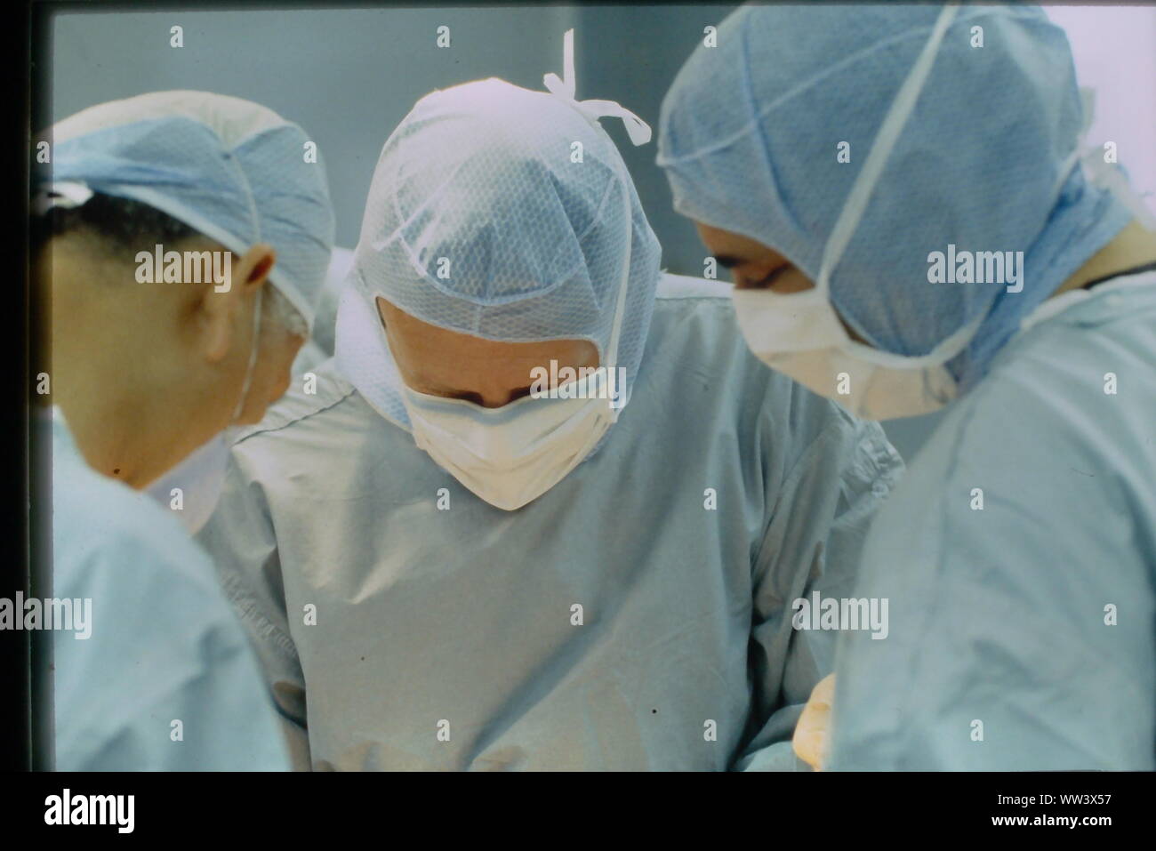 Surgeons performing knee replacement in sterile surgical scene Stock ...