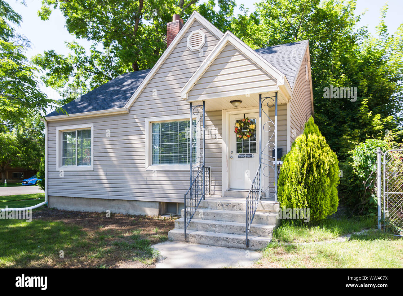 Sunny shot of simple tan house in suburban neighborhood Stock Photo - Alamy
