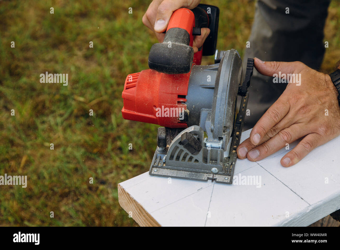 Carpenter Using Circular Saw for wood beam a new home constructiion ...