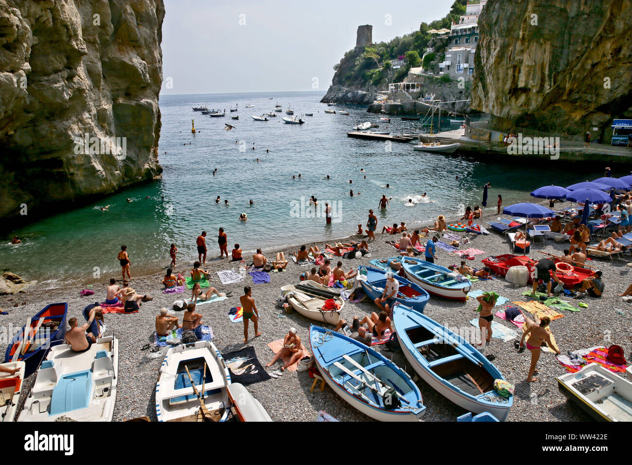 Swimmers and beachgoers enjoy a summer's day at Praiano Beach in ...