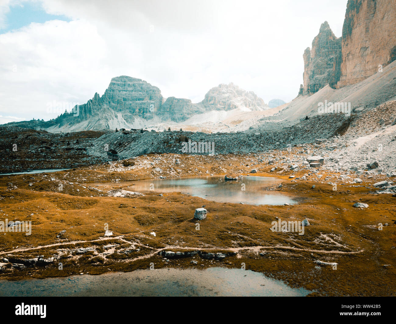 Mountain range in morning sunrise with sun flare in the dolomites italy ...
