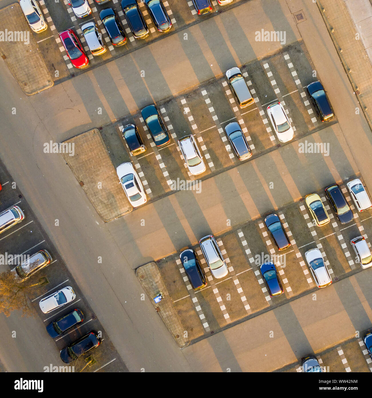 Small parking lot with parked vehicles and empty places Stock Photo - Alamy