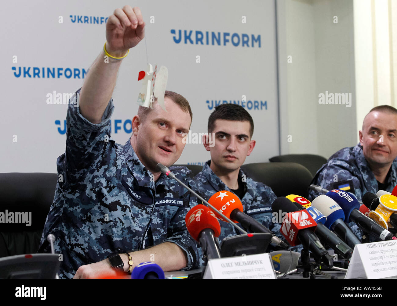 Ukrainian sailor, Denys Hrytsenko shows a handmade toy made by Ukrainian children, which he ...