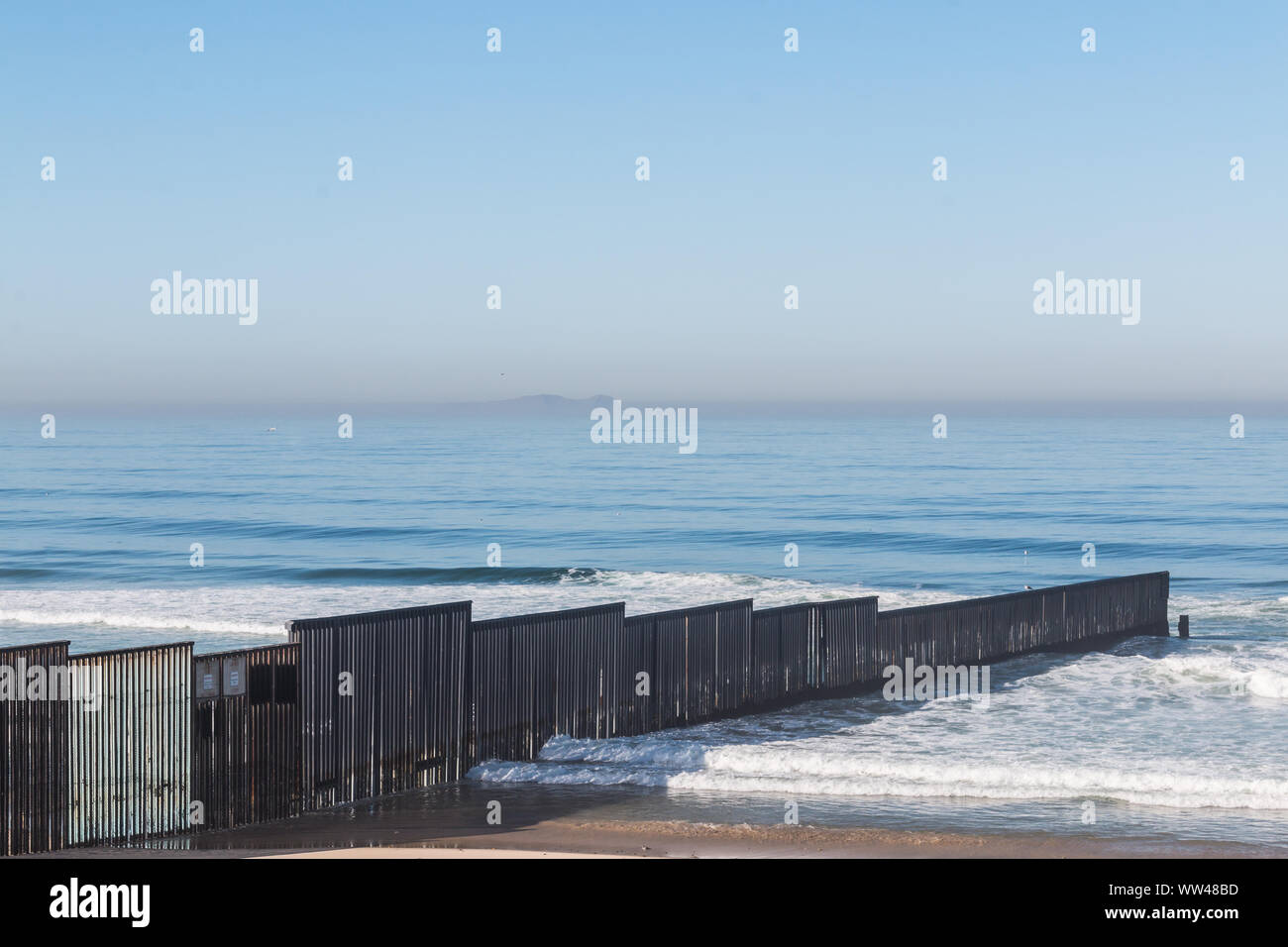 The international border wall extending out into the ocean and ...